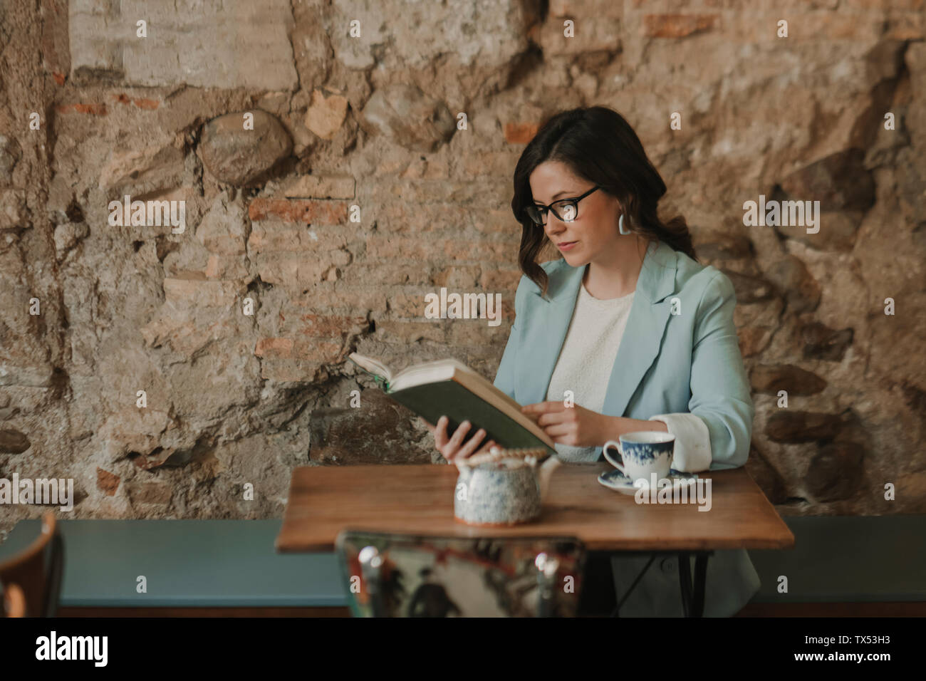 Reading a book at a cafe hi-res stock photography and images - Alamy