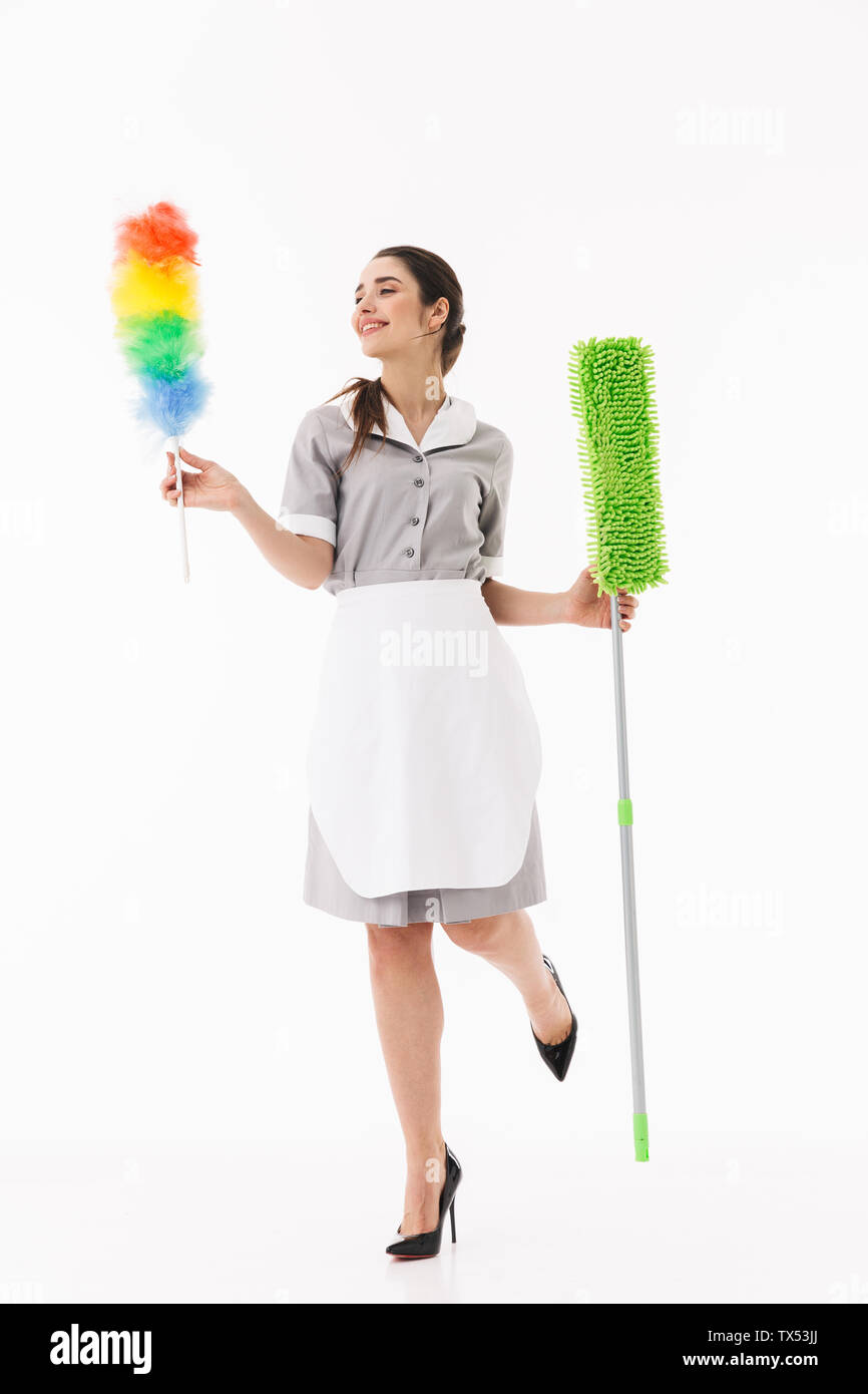 Full length photo of caucasian maid 20s dressed in uniform holding ...
