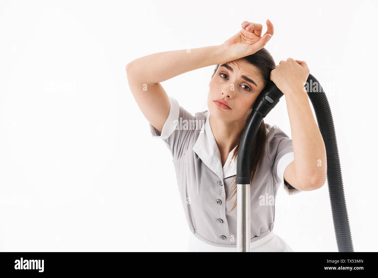 Image of overworked maid 20s dressed in uniform cleaning floor with ...