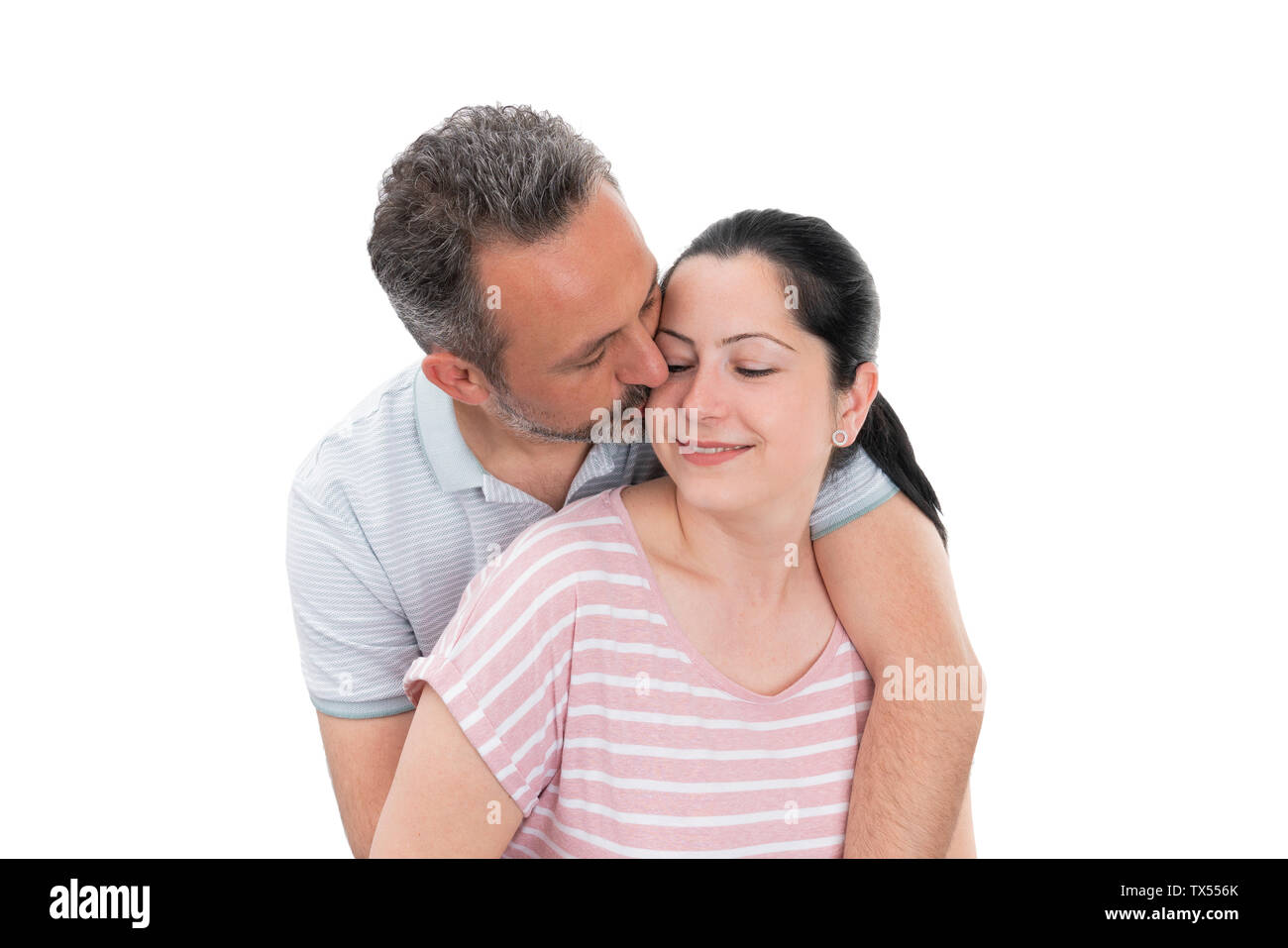 Closeup of loving man and woman hugging and kissing cheek as couple ...