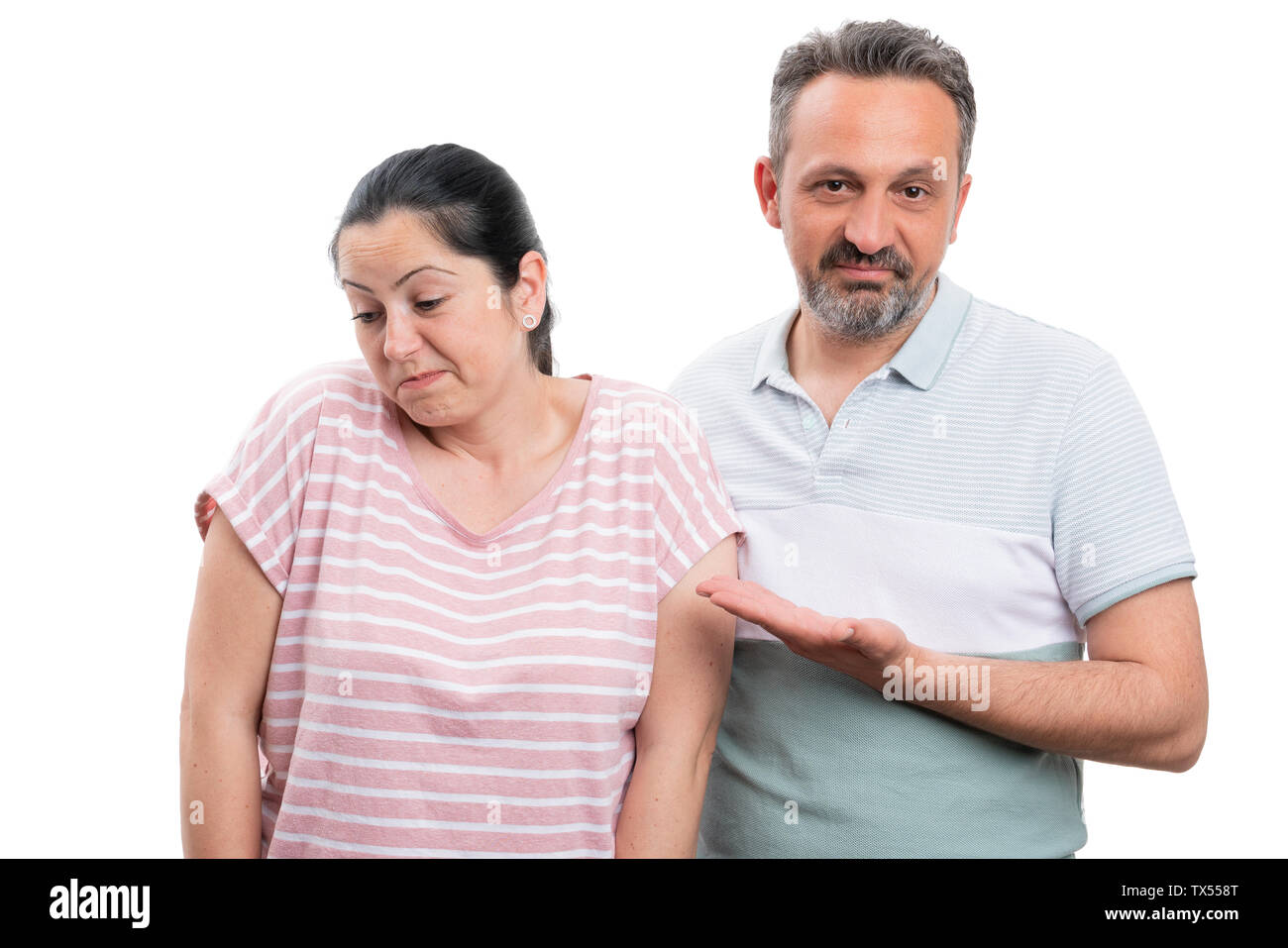 Man pointing palm and presenting woman with disinterested expression as ...