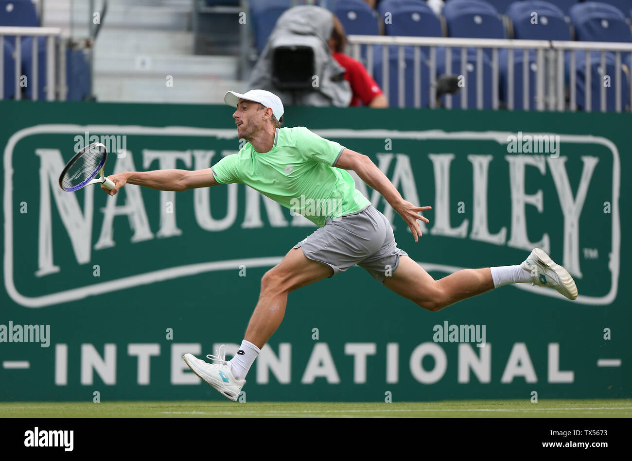 Eastbourne, UK. 24 June 2019 John Millman of Australia at full stretch ...