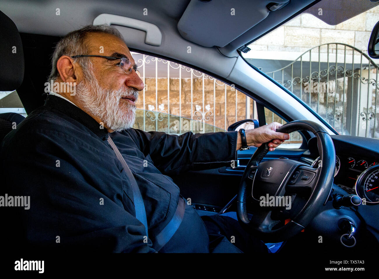 Melkite (Greek catholic) priest Emile Shoufani driving his car Stock ...