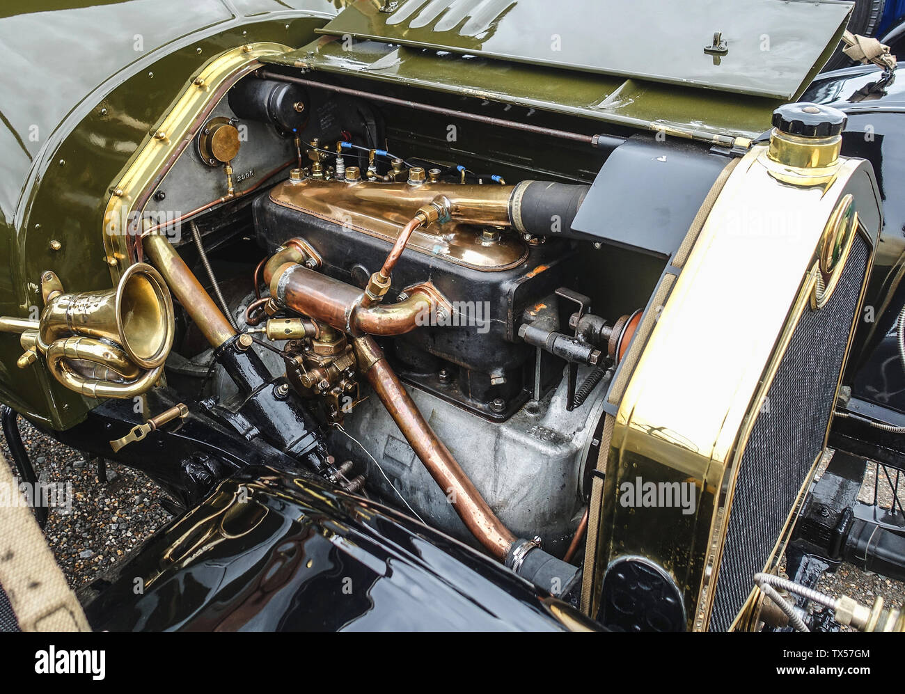 Gleaming brass and copper in the engine compartment of a 1912 Crossley ...