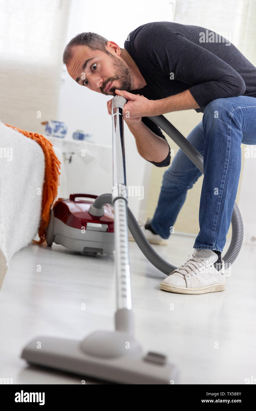 A man vacuuming Stock Photo - Alamy