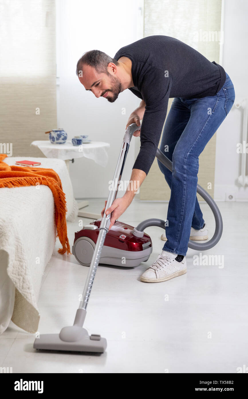 A man vacuuming Stock Photo - Alamy