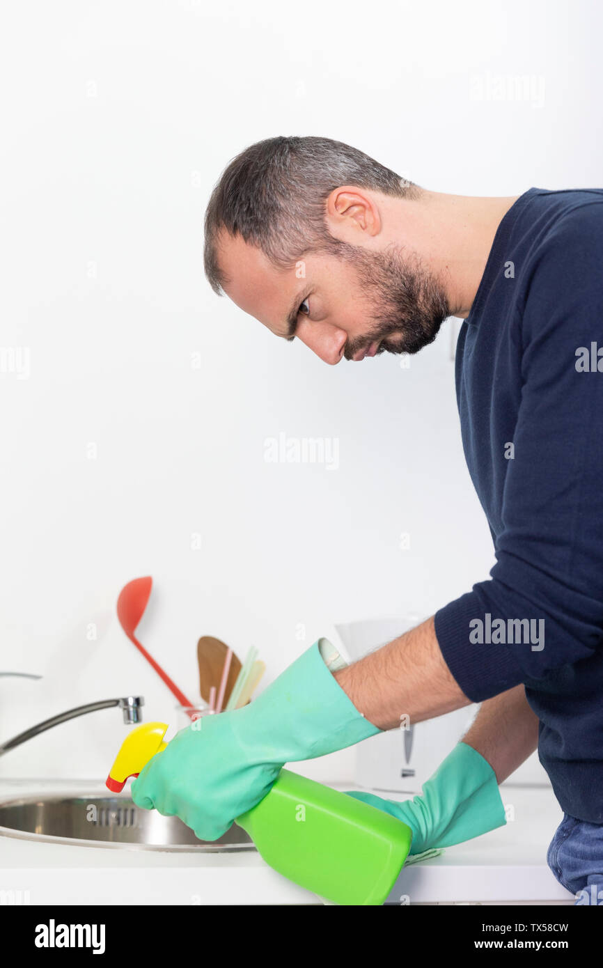 A man using cleaning products to clean Stock Photo - Alamy