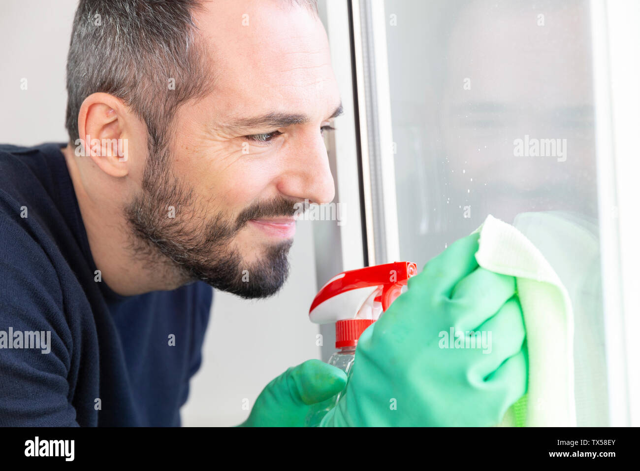 A man cleaning a window Stock Photo - Alamy