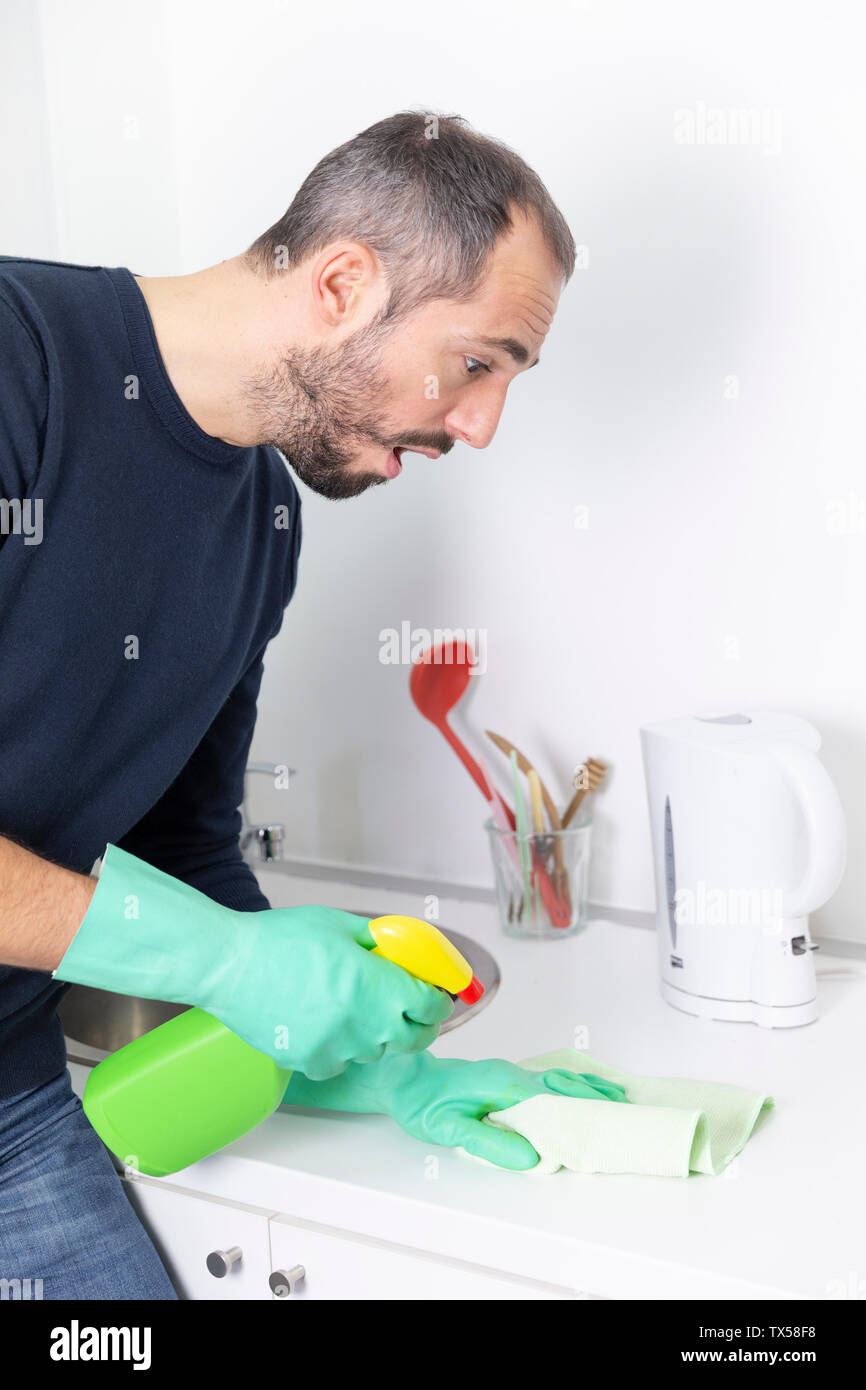 A man using cleaning products to clean Stock Photo - Alamy