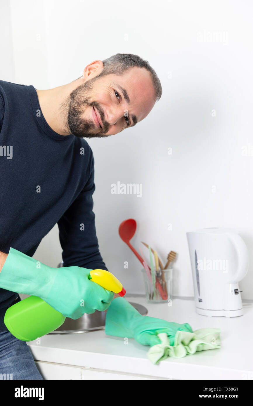 A man using cleaning products to clean Stock Photo - Alamy