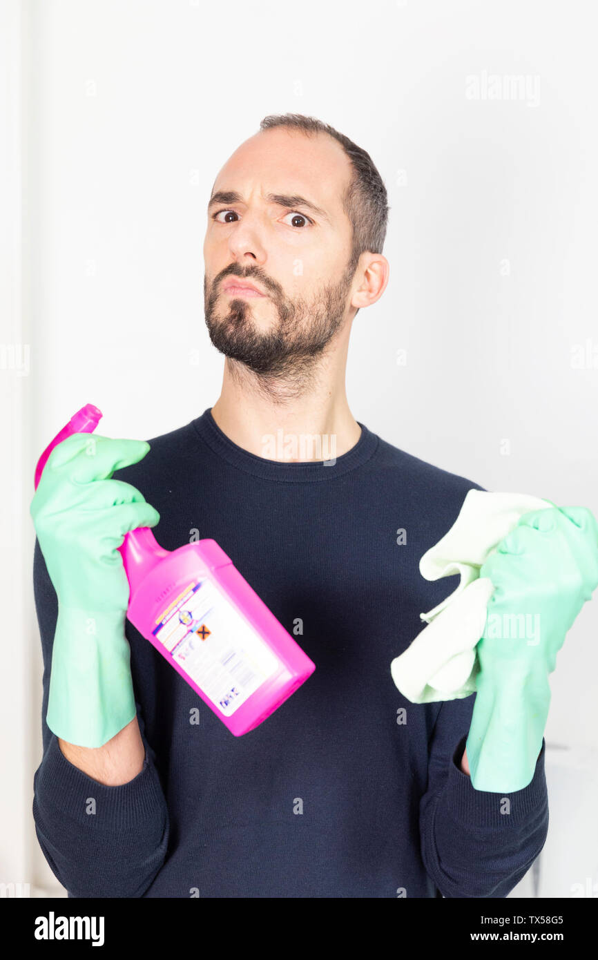A man using cleaning products to clean Stock Photo - Alamy