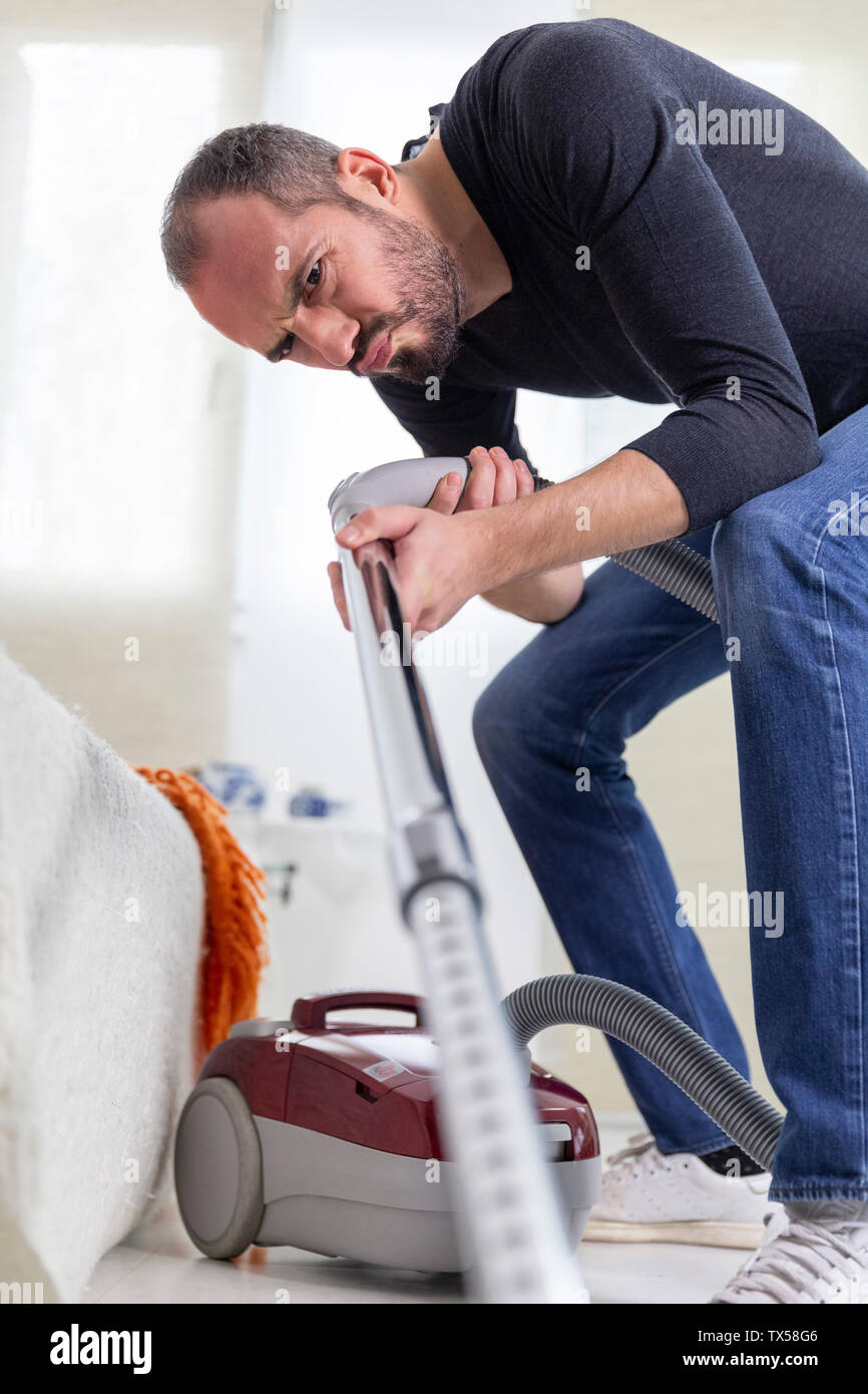A man vacuuming Stock Photo - Alamy