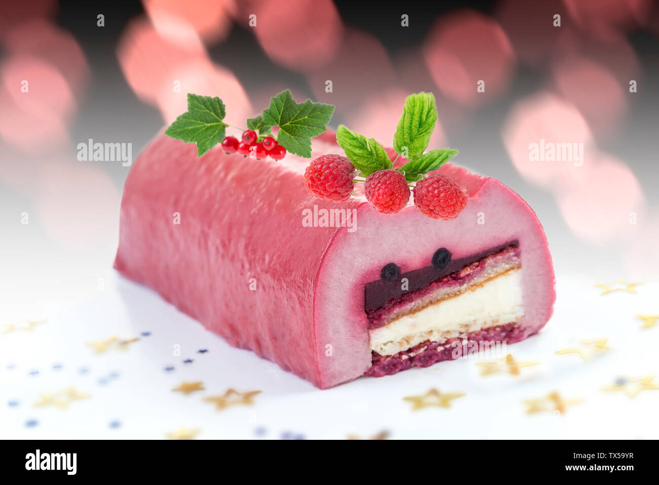 Yule log of raspberries fruits mousse Stock Photo - Alamy