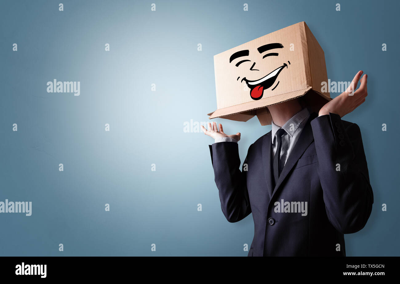 Young boy standing and gesturing with a cardboard box on his head Stock ...