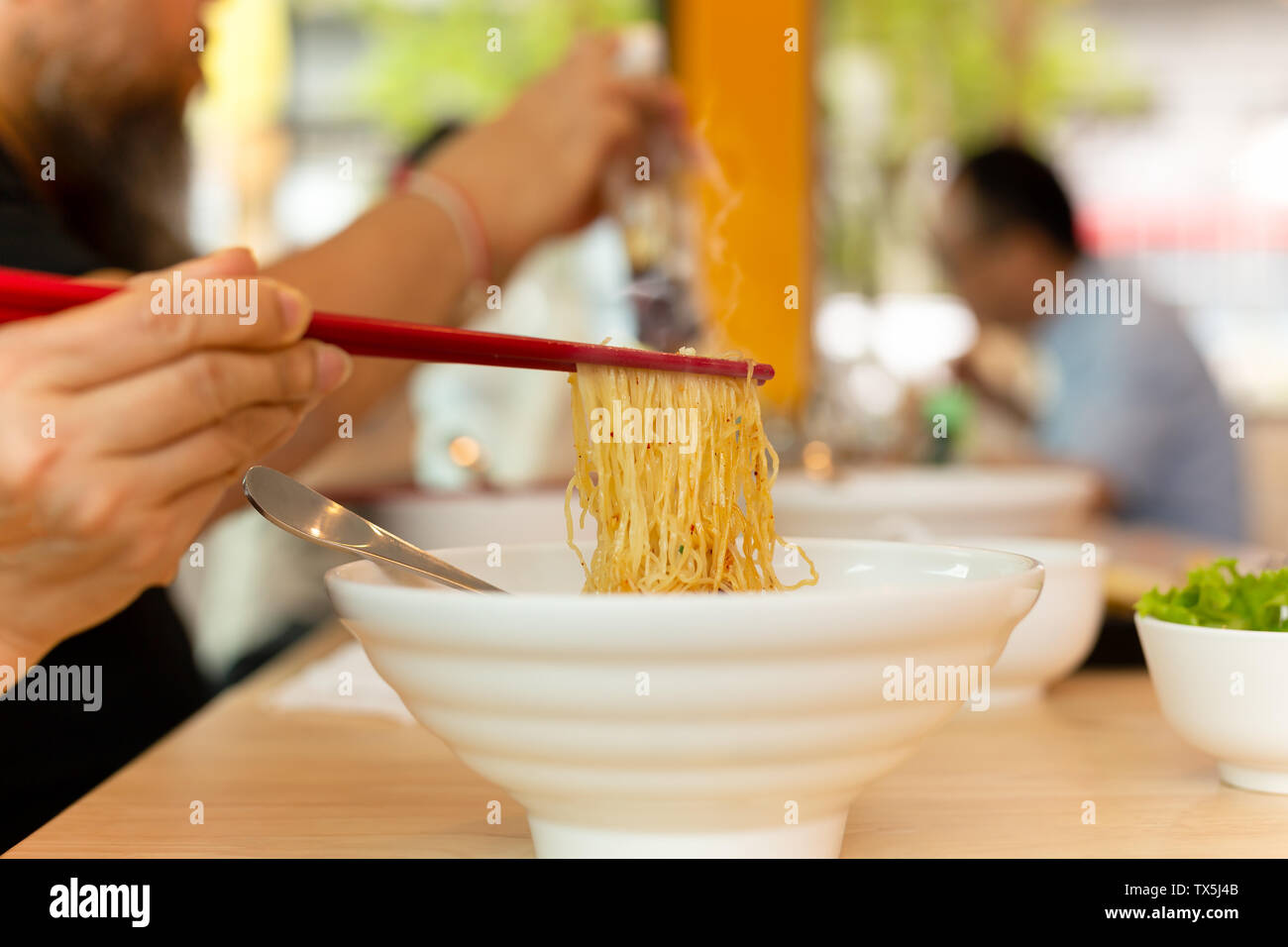 China people eating noodles hi-res stock photography and images - Alamy