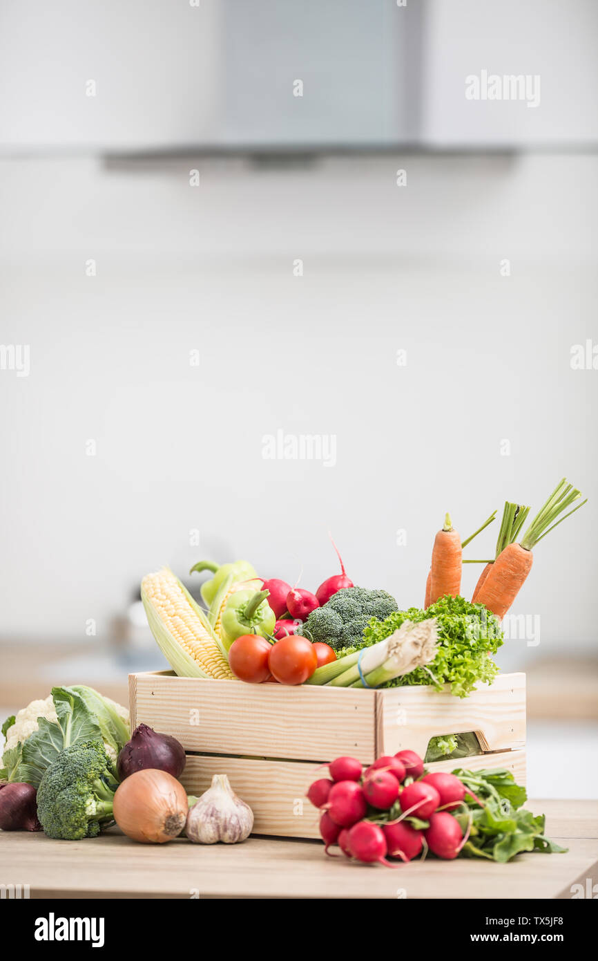 Wooden box full of fresh healthy vegetables. Broccoli carrot radish ...