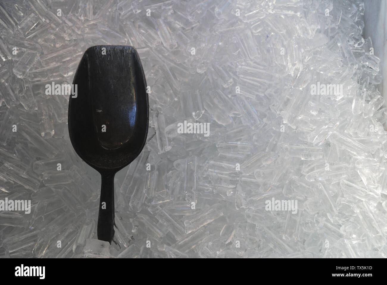 Ice in the tank with ice scoop Stock Photo - Alamy