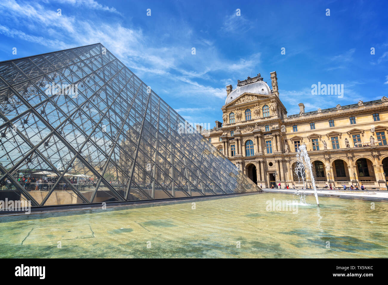 Louvre pyramid in the main courtyard of the Louvre Palace in Paris ...