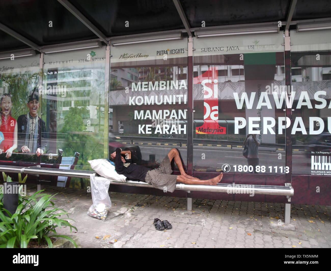 Homeless man sleeping bus stop hi-res stock photography and images - Alamy