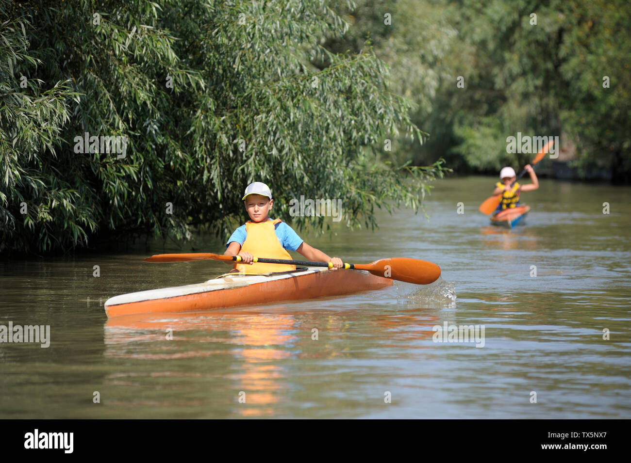 Boy rowing canoe on a canal. June 22, 2018. Vilkovo village (called ...