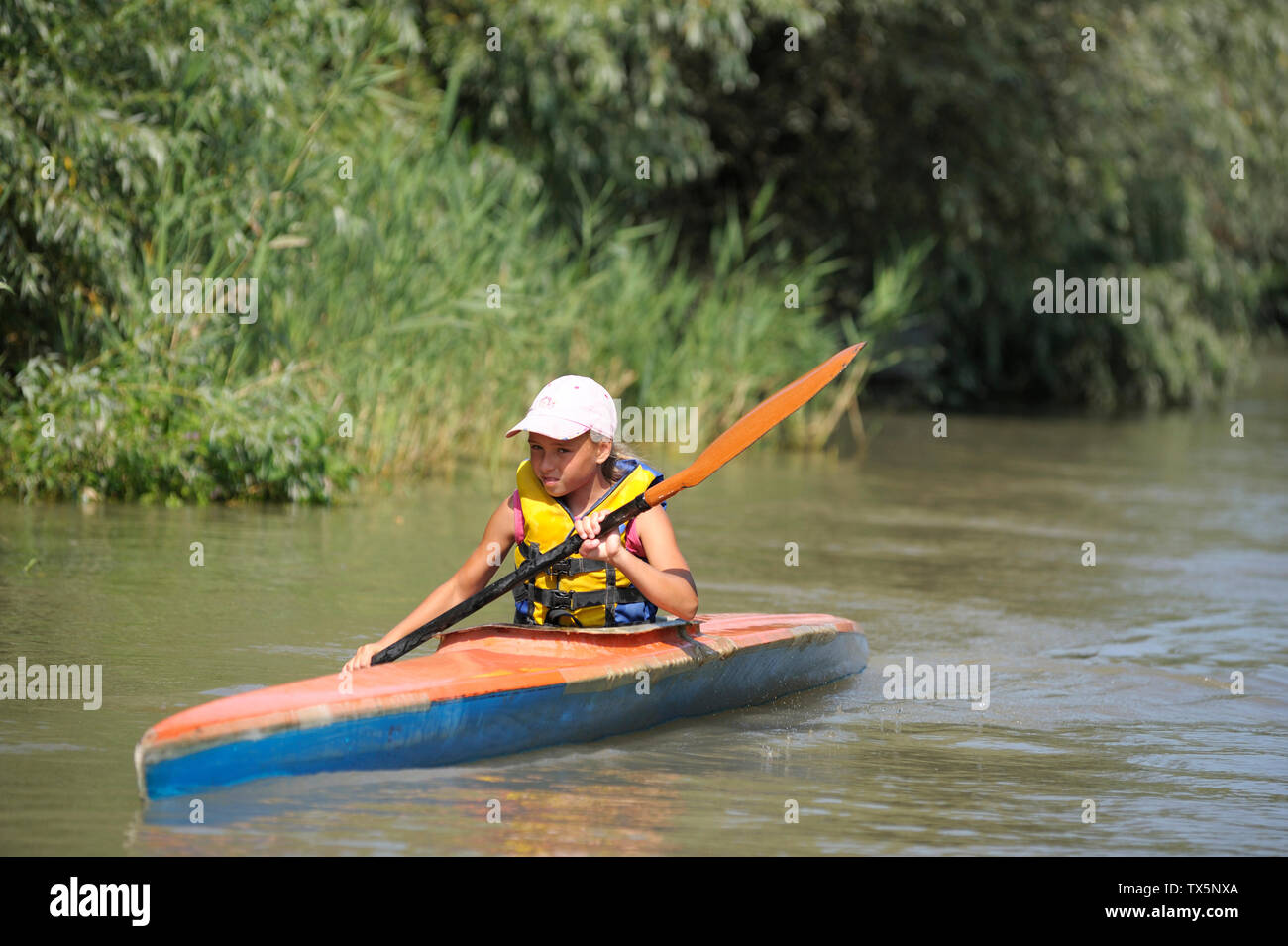 Boy rowing canoe on a canal. June 22, 2018. Vilkovo village (called ...