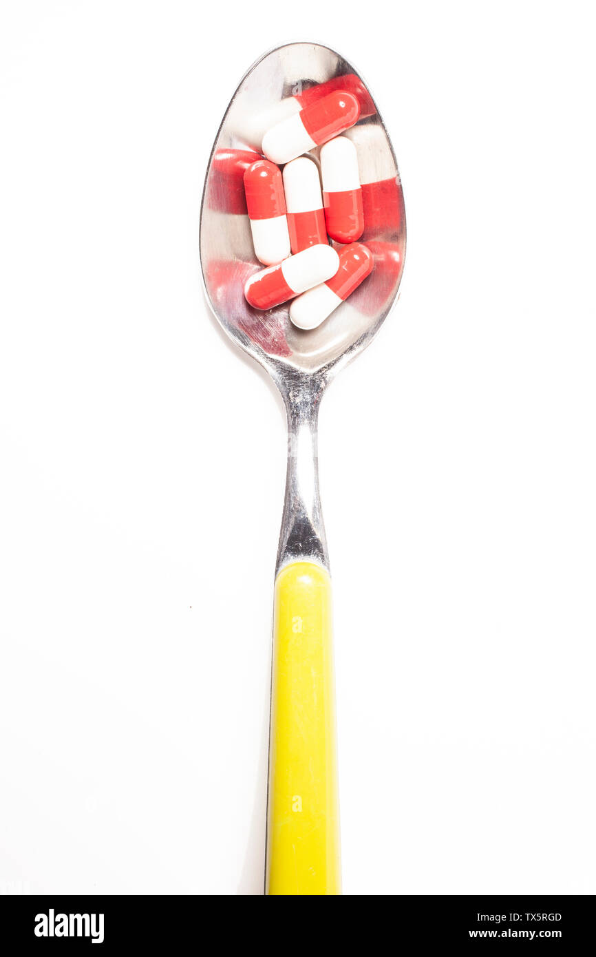 pills on spoon - isolated on white Stock Photo - Alamy