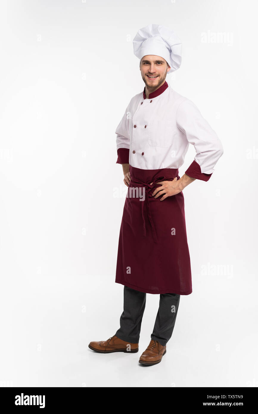 Full length portrait of positive handsome chef cook in beret and white ...