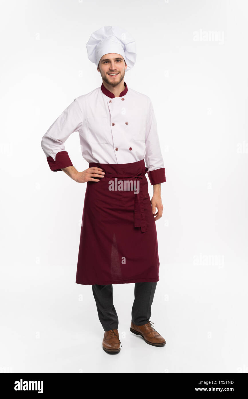 Full length portrait of positive handsome chef cook in beret and white ...