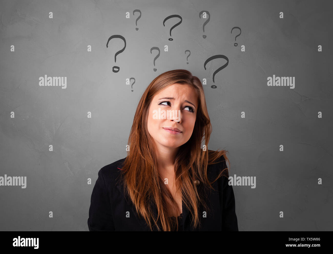 Person with question marks around face Stock Photo - Alamy