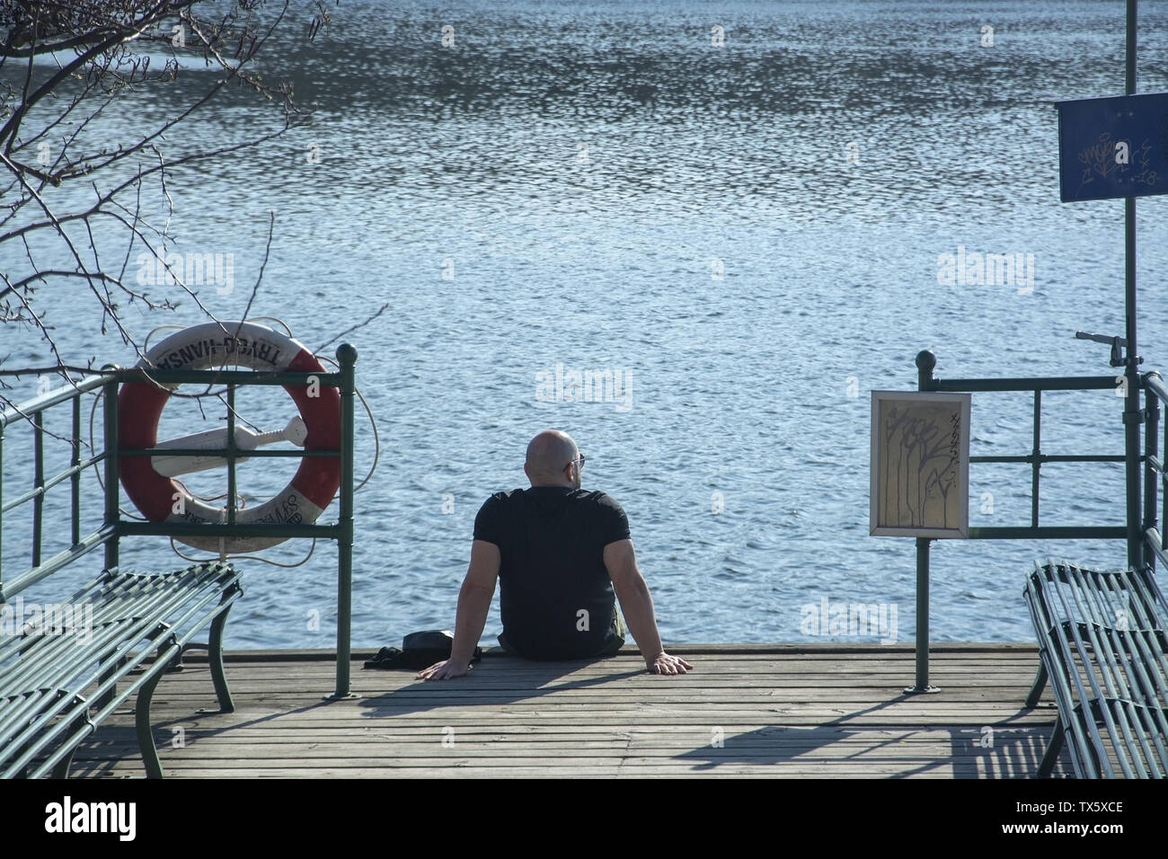 Man sitting on dock hi-res stock photography and images - Alamy