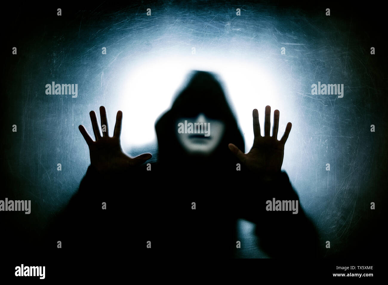 Ghostly figure behind a dusty scratched glass. Mystery man with mask ...