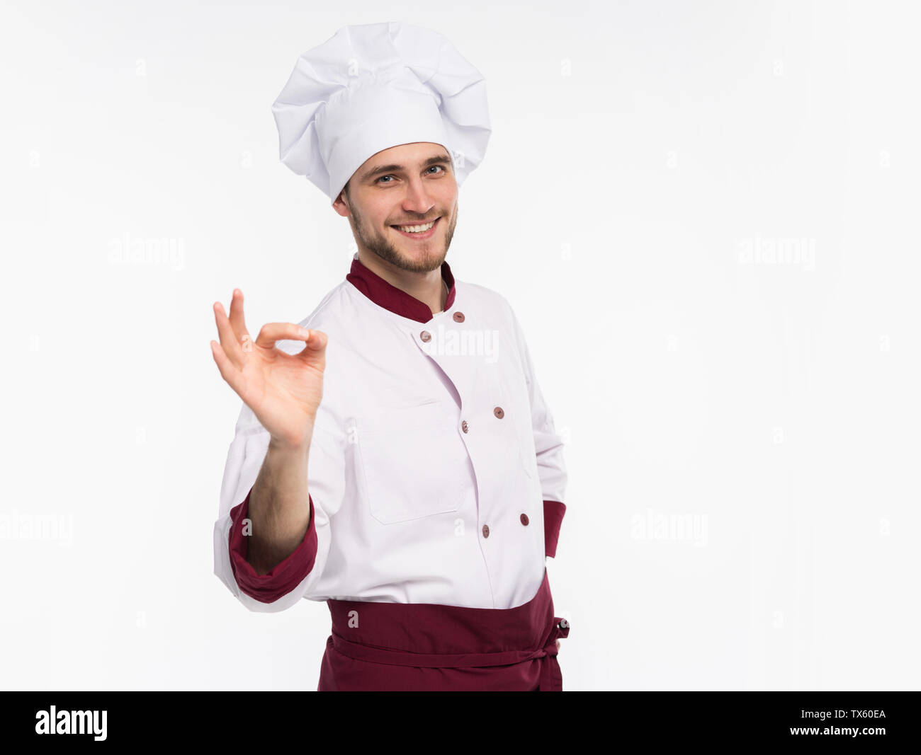 Positive professional happy man chef showing tasty ok sign isolated on ...