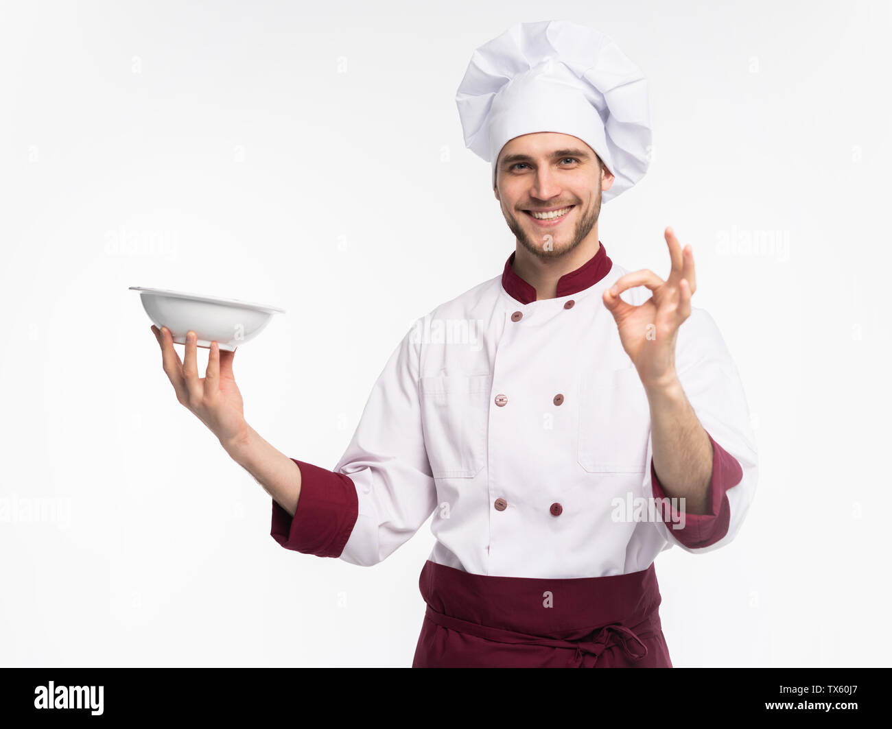 Positive professional happy man chef showing tasty ok sign isolated on ...