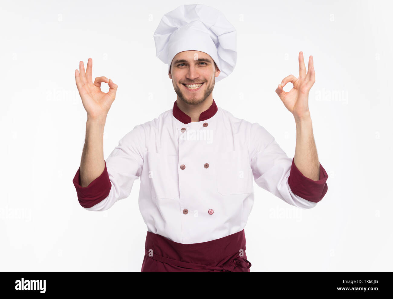 Positive professional happy man chef showing tasty ok sign isolated on ...