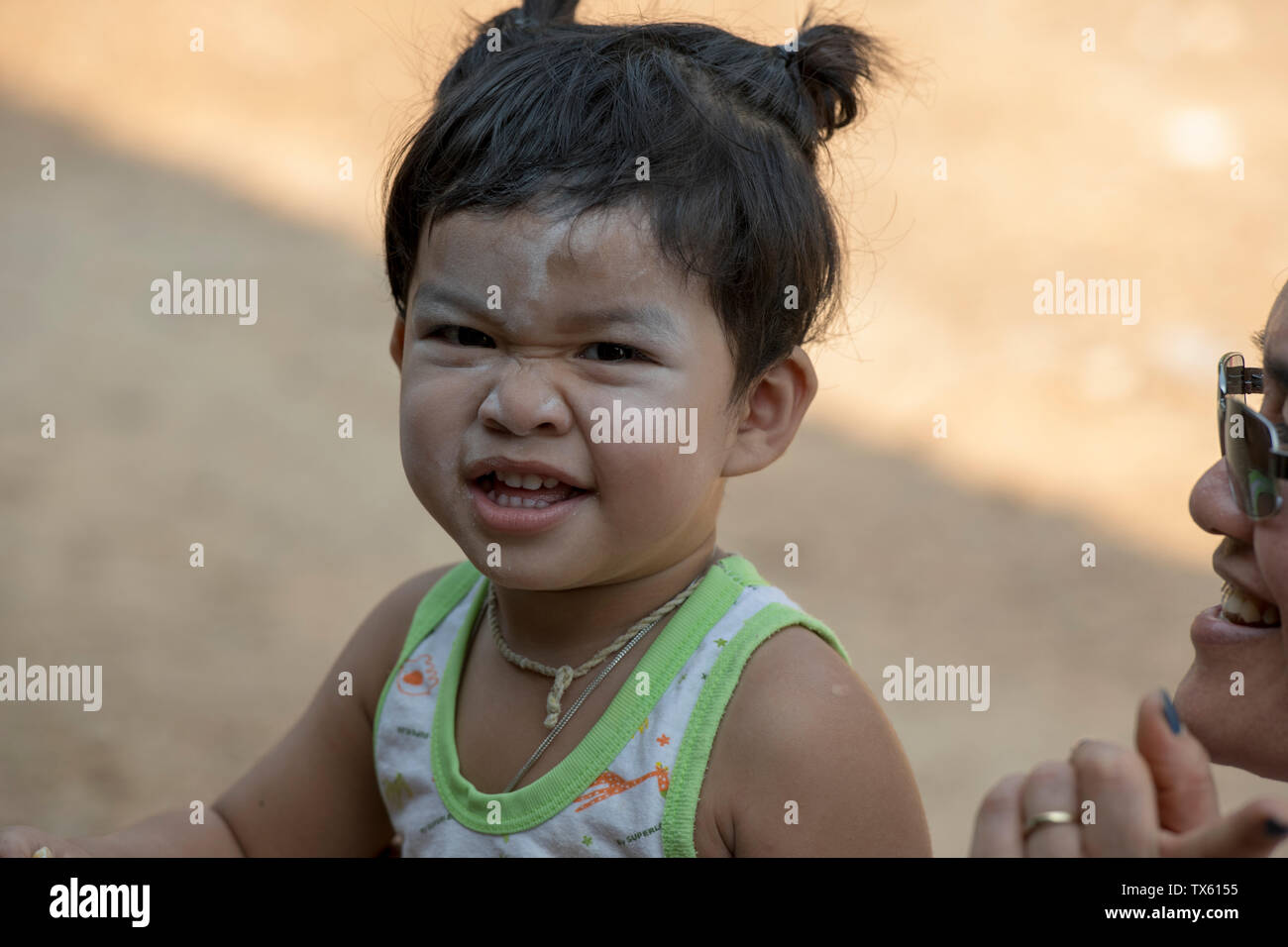 Young girl with cheeky smile Stock Photo - Alamy