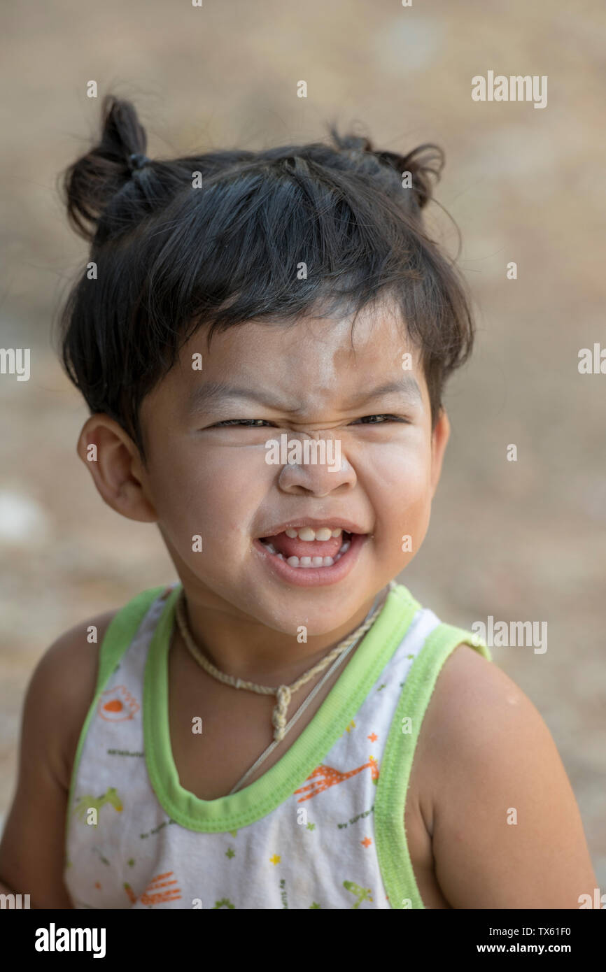 Young girl with cheeky smile Stock Photo - Alamy