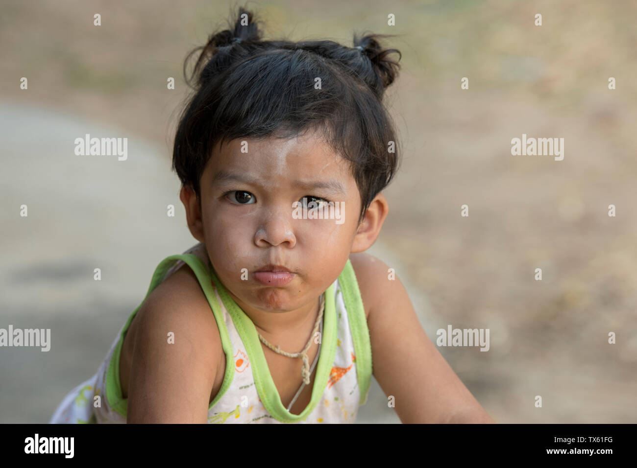 Young girl with cheeky smile Stock Photo - Alamy