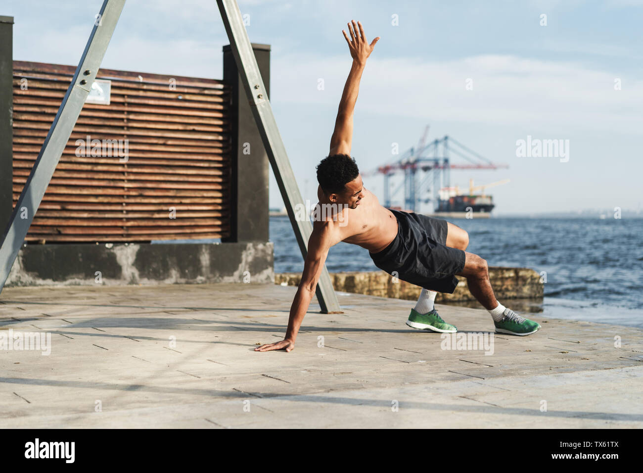 Confident fit african man working out outdoors at the seafront Stock ...