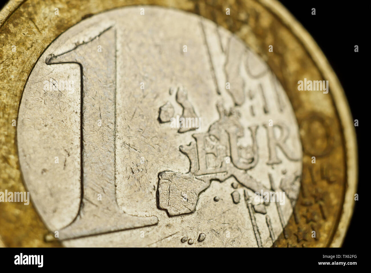 one euro coin close up isolated on black background. Detail of metallic ...