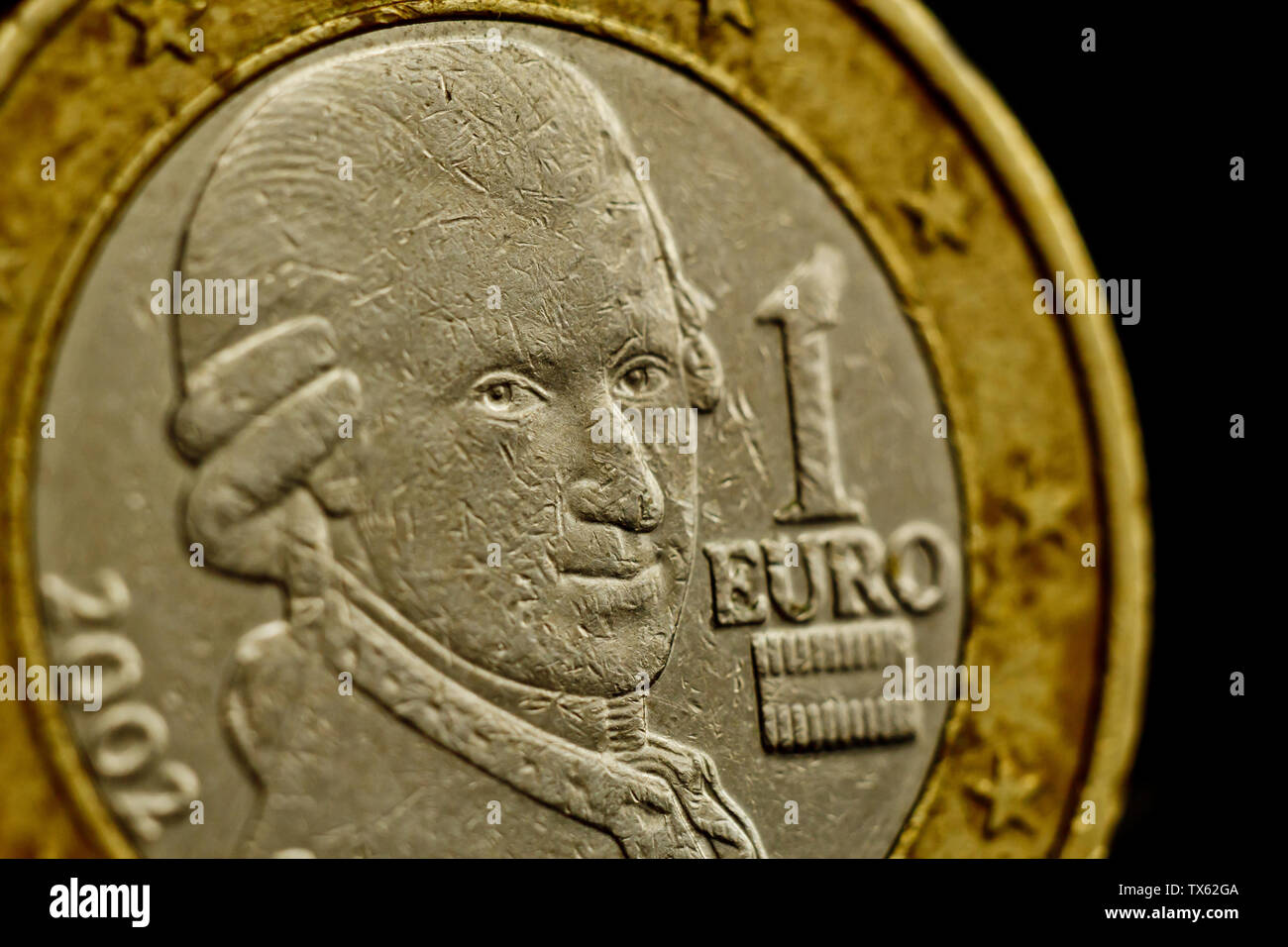 one euro coin close up isolated on black background. Detail of metallic ...