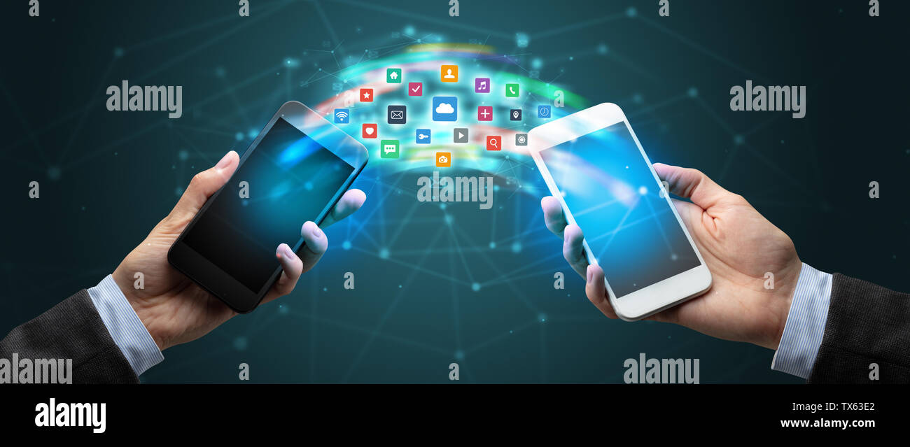 Two mobile phones syncing applications concept Stock Photo - Alamy