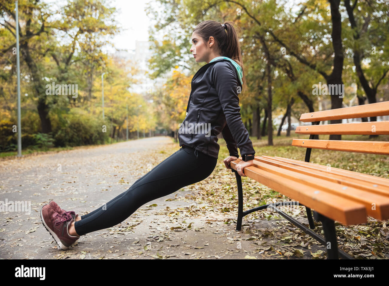 Photo of amazing young pretty fitness woman outdoors in the park make ...