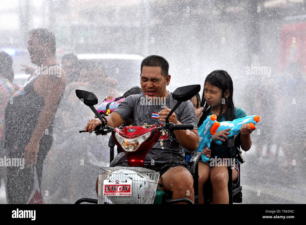 San Juan, Philippines. 24th June, 2019. A man and two children are ...
