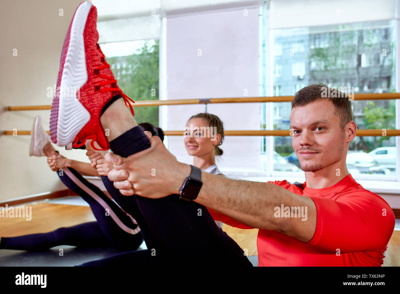 Fitness group does exercises for stretching muscles in a fitness lesson ...