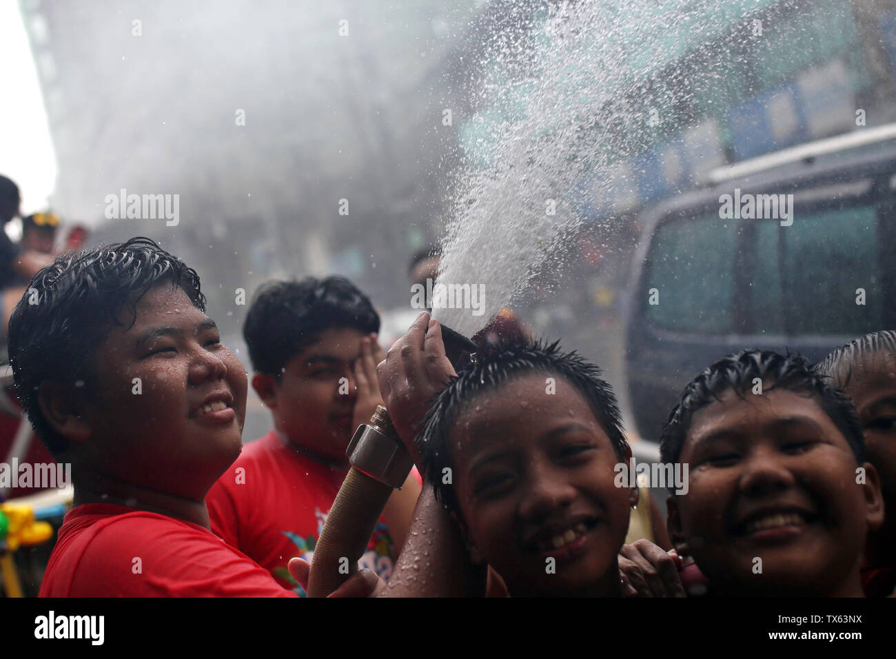 San Juan, Philippines. 24th June, 2019. A boy sprays water through the ...
