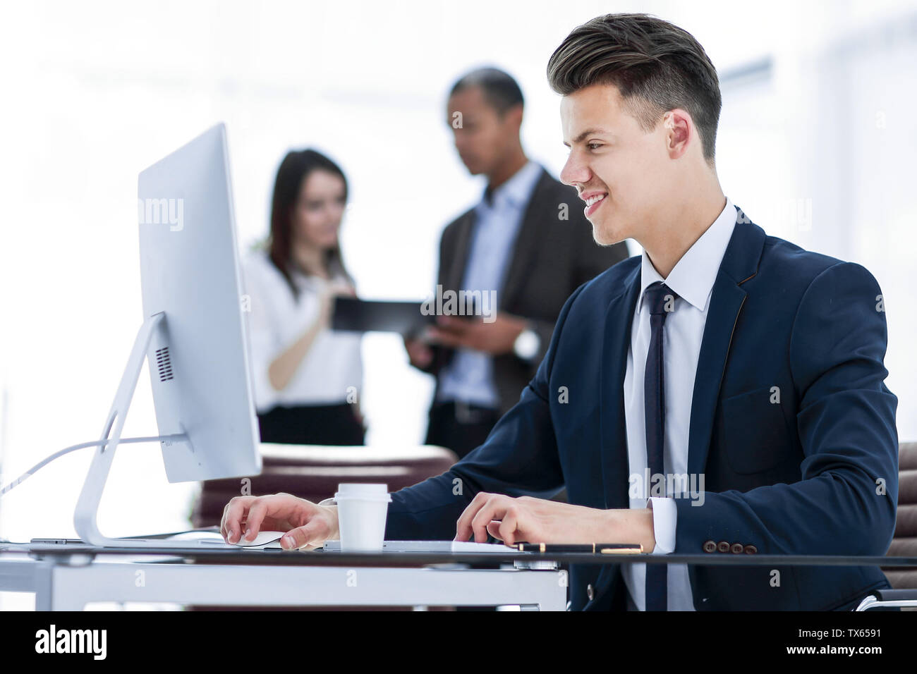 employee sitting behind a Desk in the office .photo with copy space ...