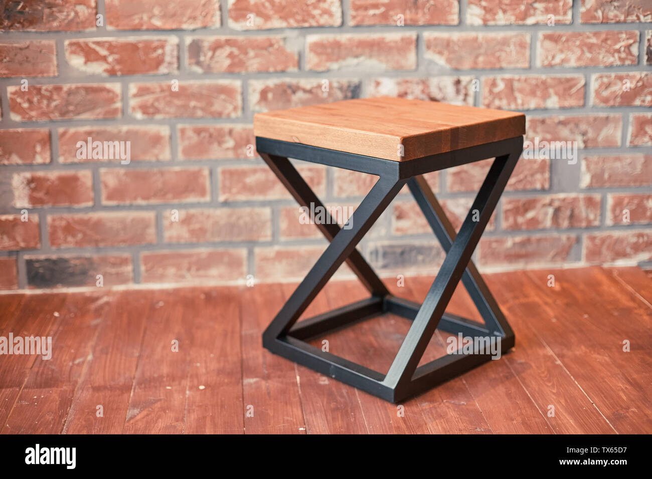 stylish stool against a red brick wall. photo with copy space Stock ...