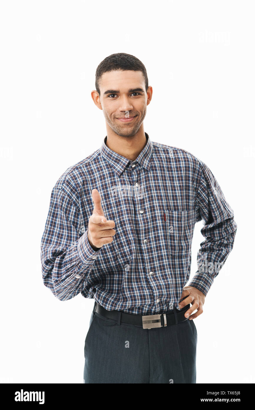 Portrait of a happy young man wearing plaid shirt standing isolated ...