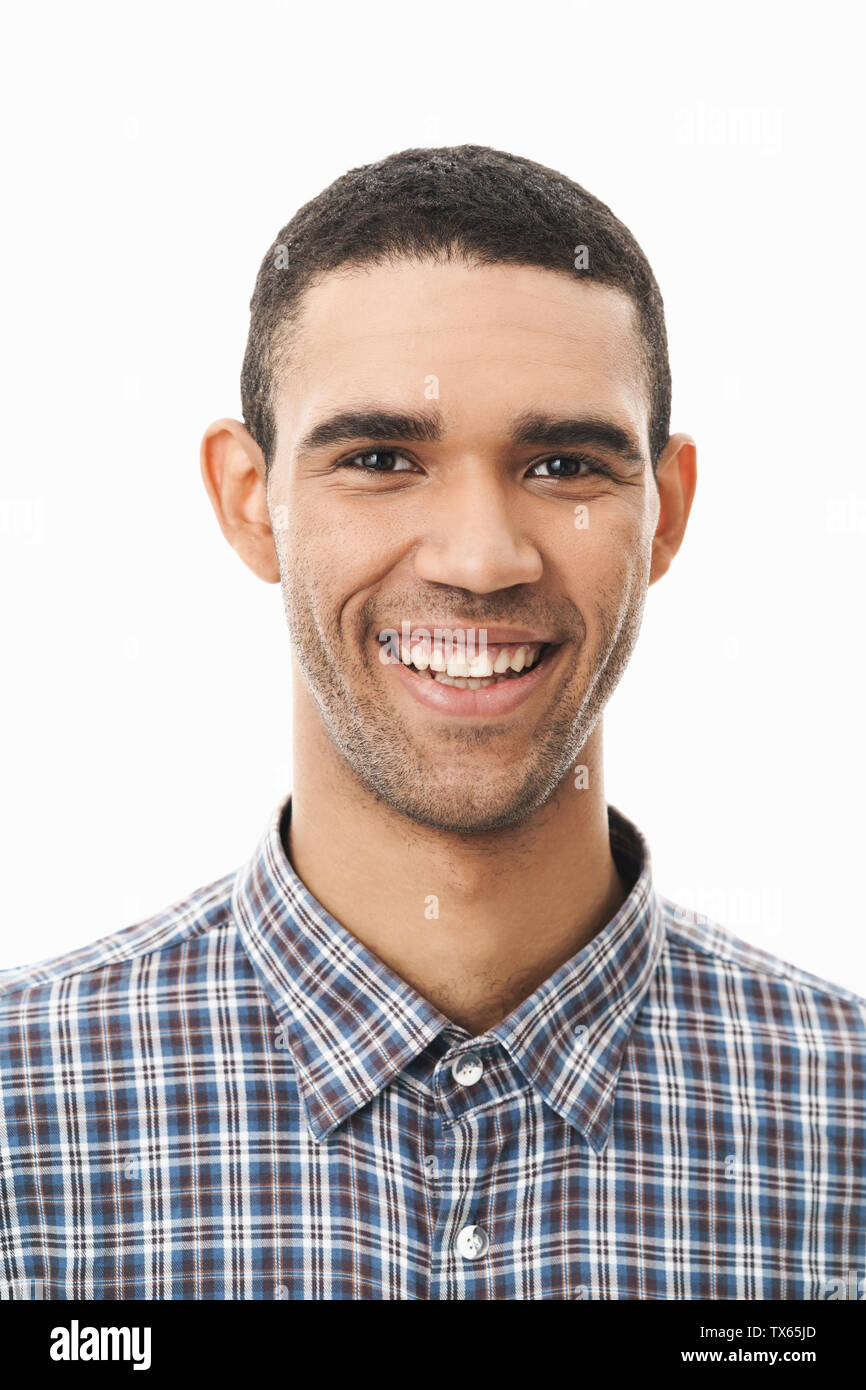 Close up of a happy young man wearing plaid shirt standing isolated ...