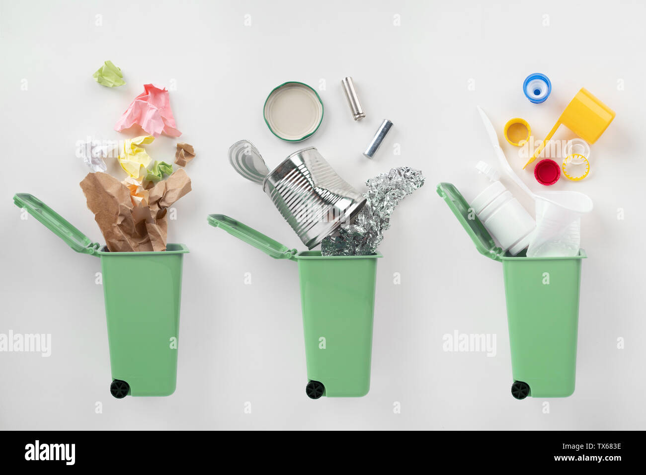 Trash bins and assorted garbage on grey background. Recycle concept ...